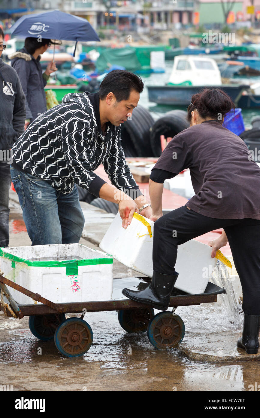 Chinese Man And Woman Loading Fish At The Market On Cheung Chau Island ...