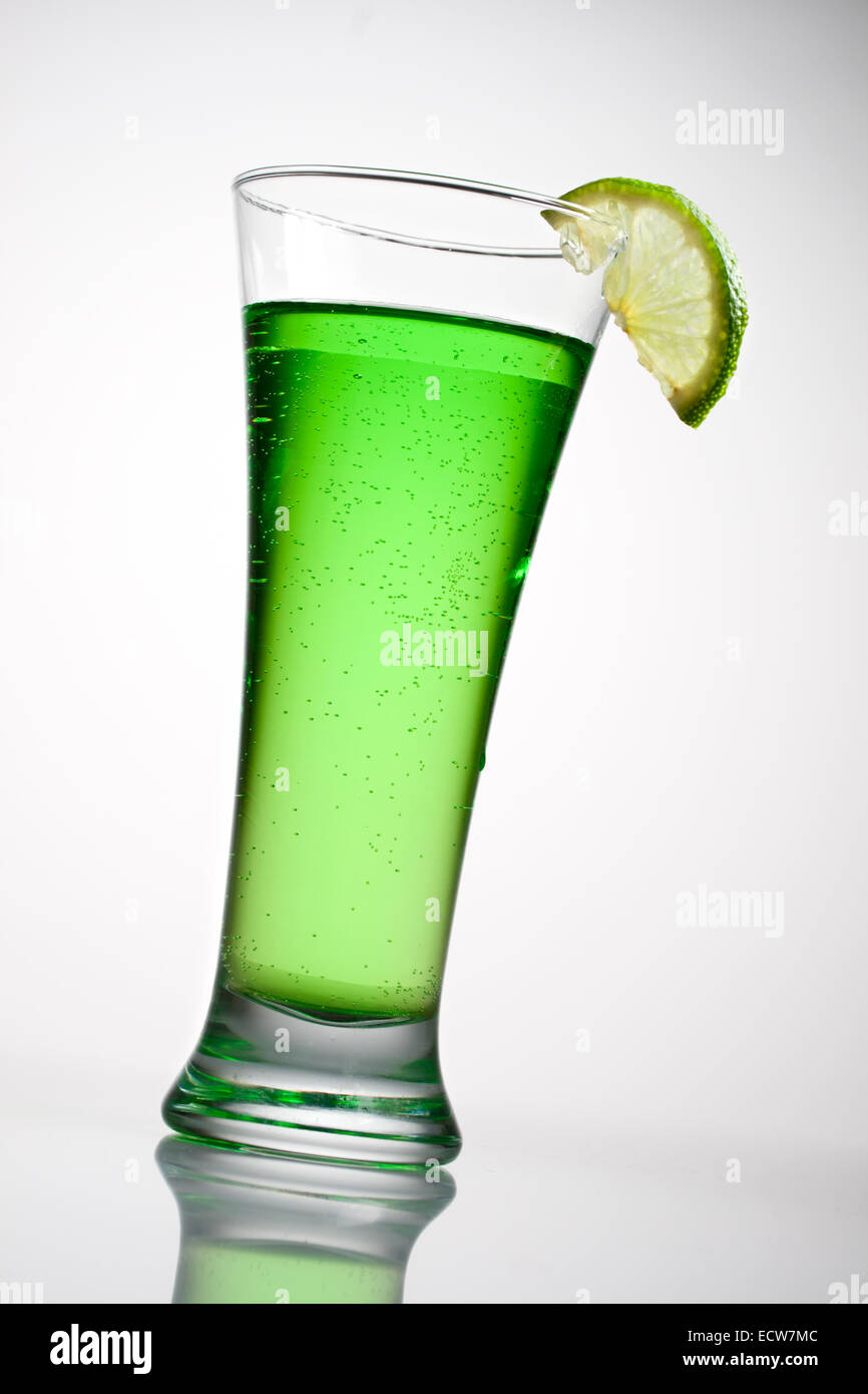 Green cocktail with a slice of lime Stock Photo - Alamy