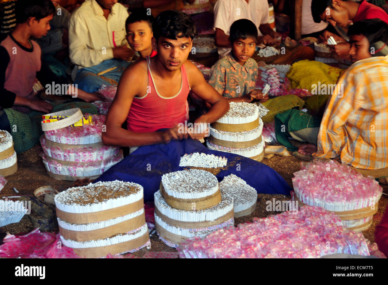 2010. Child worker at a hand rolled cigarette (locally called a bidi ...
