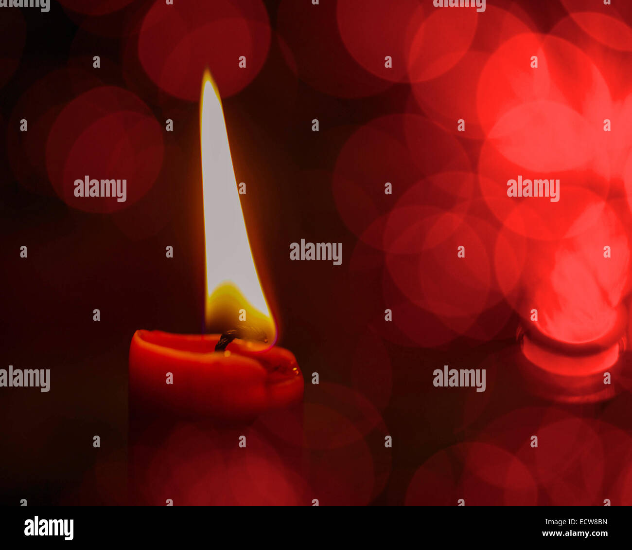 Lit candle flame with lights Stock Photo - Alamy