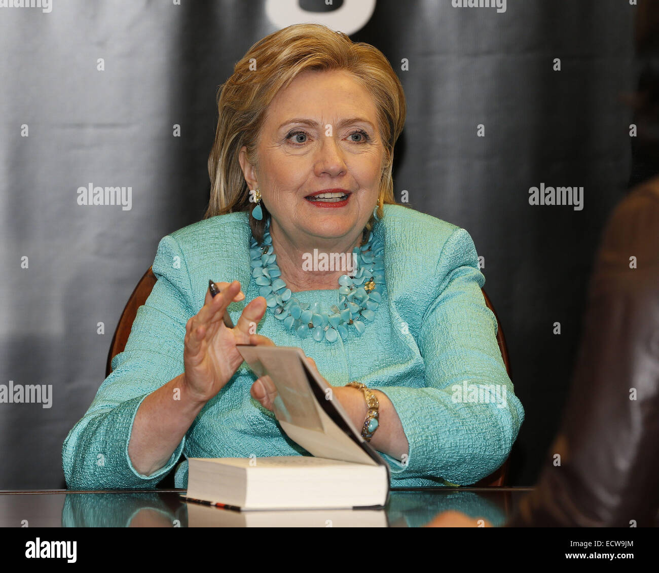 Former U.S. Secretary of State and First Lady Hillary Clinton signs ...