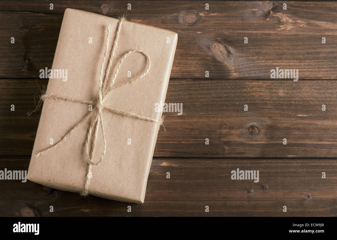 parcel wrapped packaged box on wooden background Stock Photo - Alamy