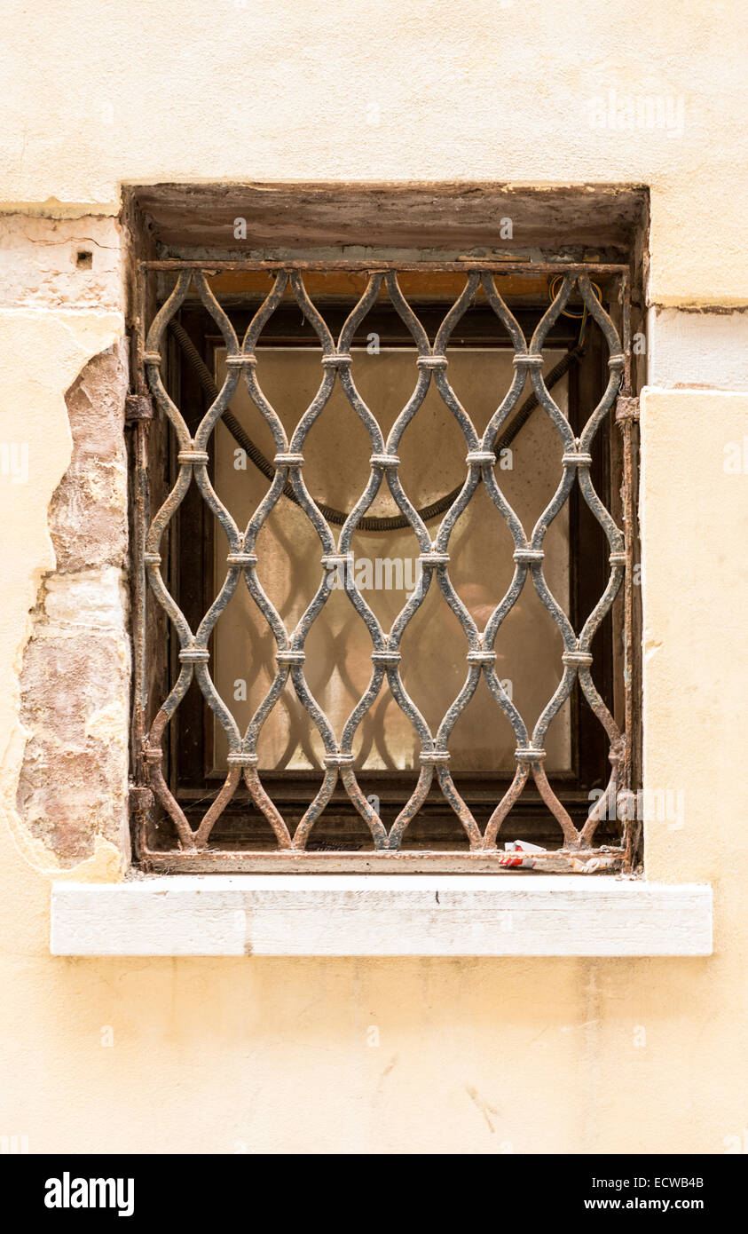 A ground floor window at Venice, Italy, protected by decorative, iron ...
