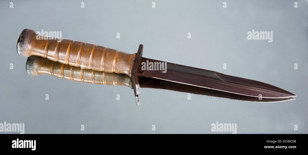 dagger with a reflection on gray background Stock Photo - Alamy