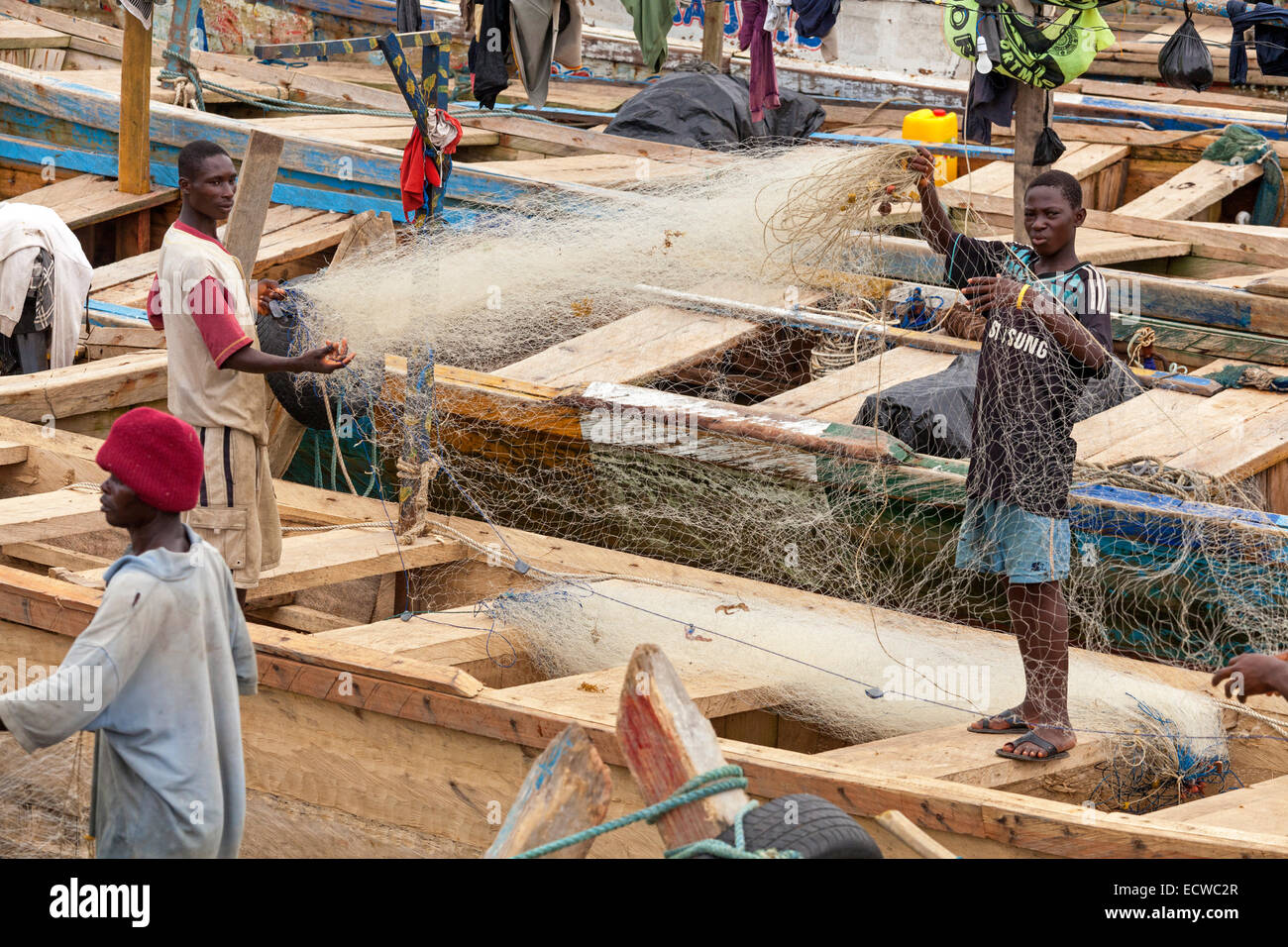 Fishing boats, fishermen and nets at Elmina harbour, Ghana, Africa ...