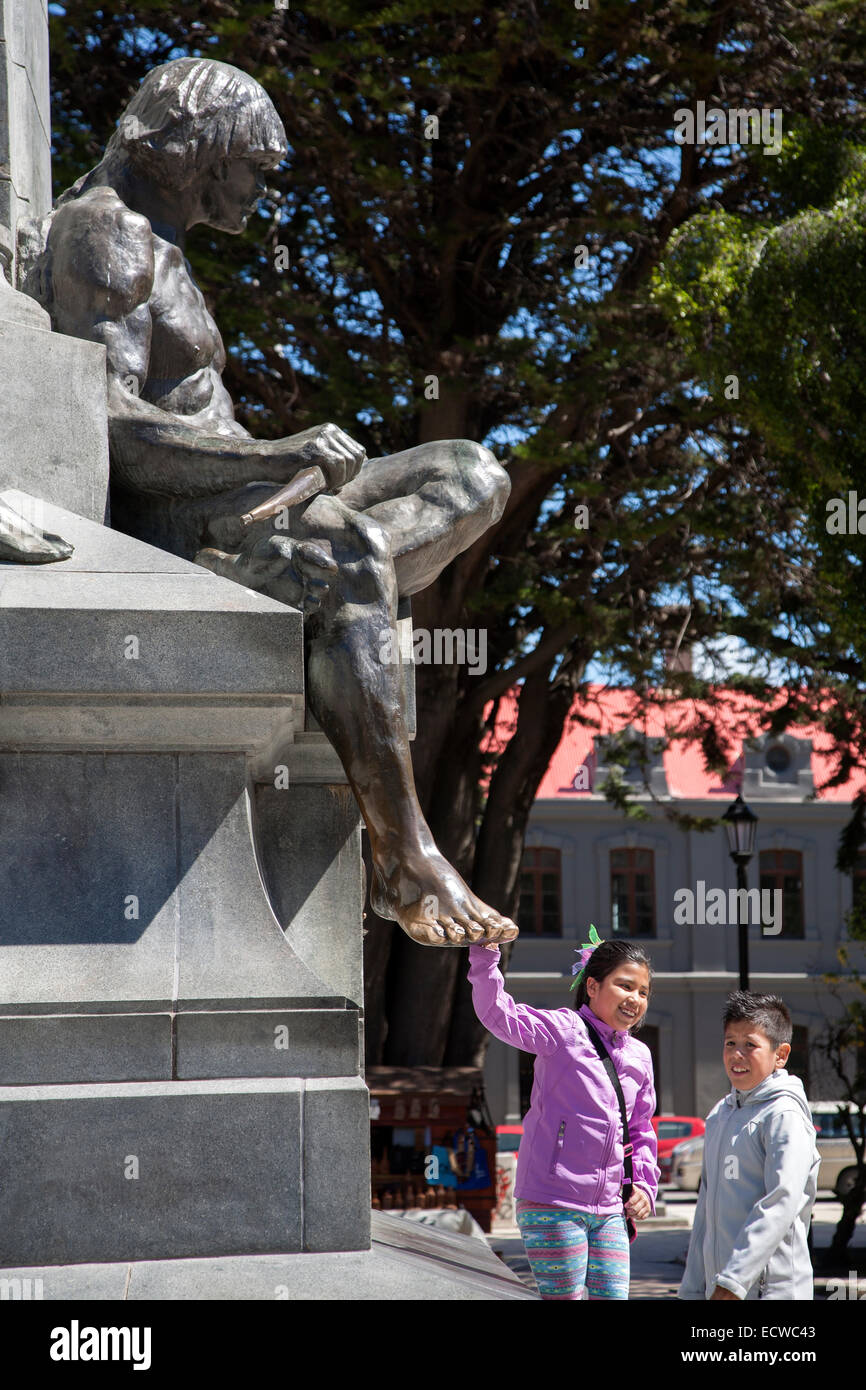 Girl touching the foot of the indian patagon statue (local behavior for ...
