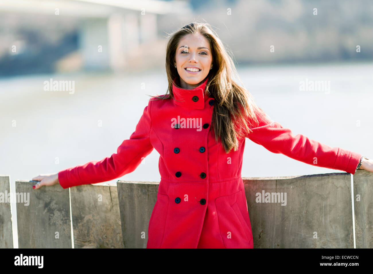 Pretty young woman in red coat Stock Photo - Alamy