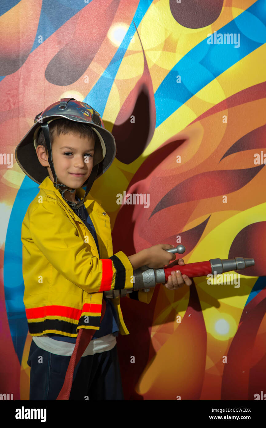 Cute little boy dressed as firefighter Stock Photo - Alamy