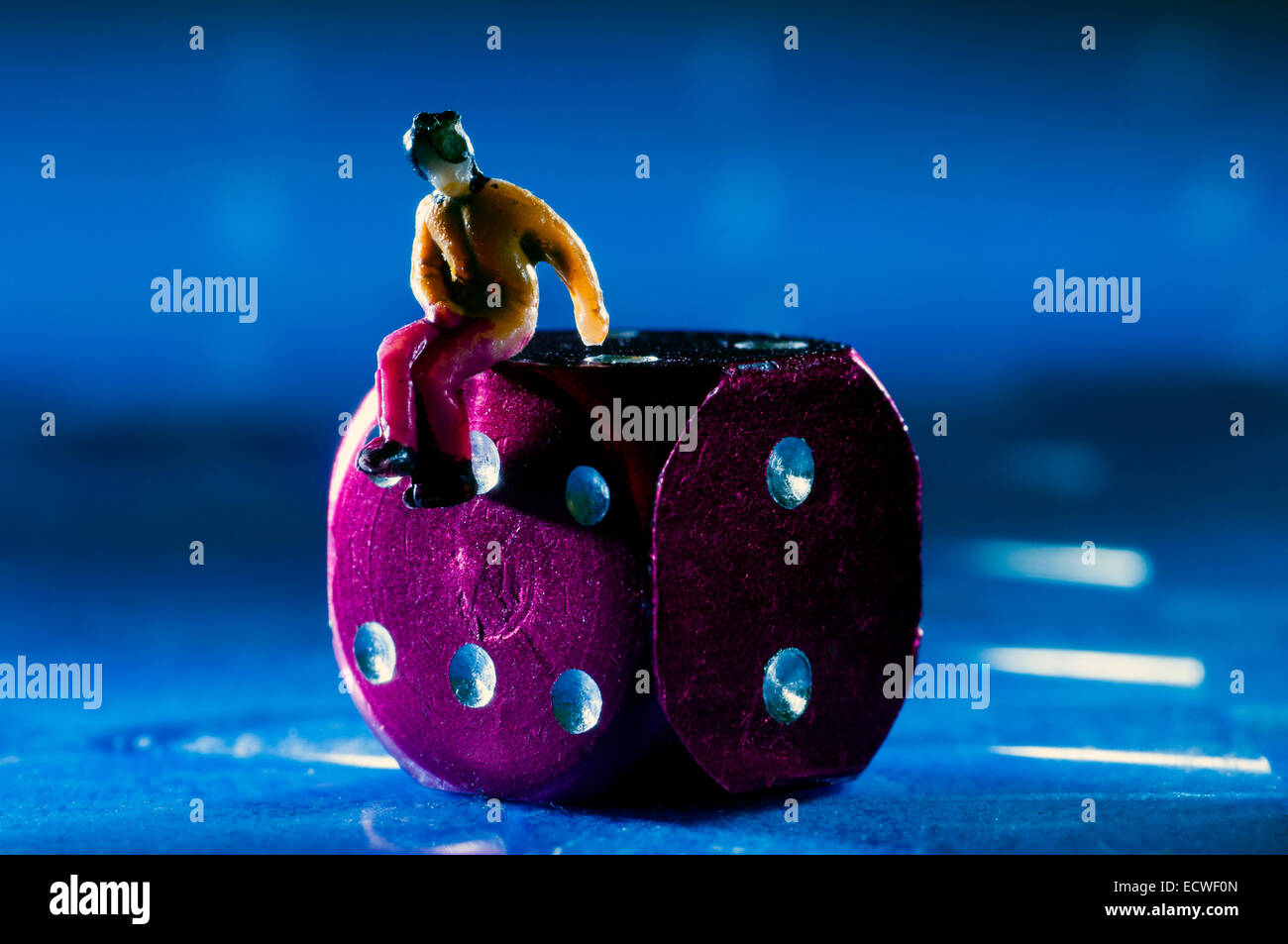 Dice with mini figure in studio setting Stock Photo - Alamy