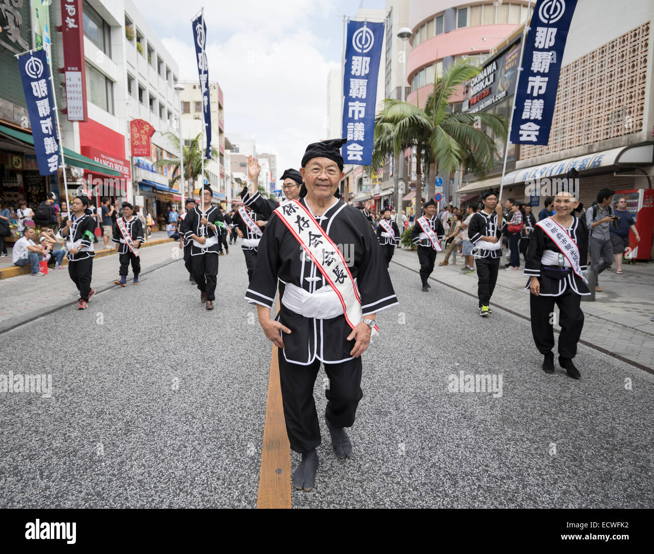 Minoru Higa, an iconic karate master, leads the parade along Kokusai ...