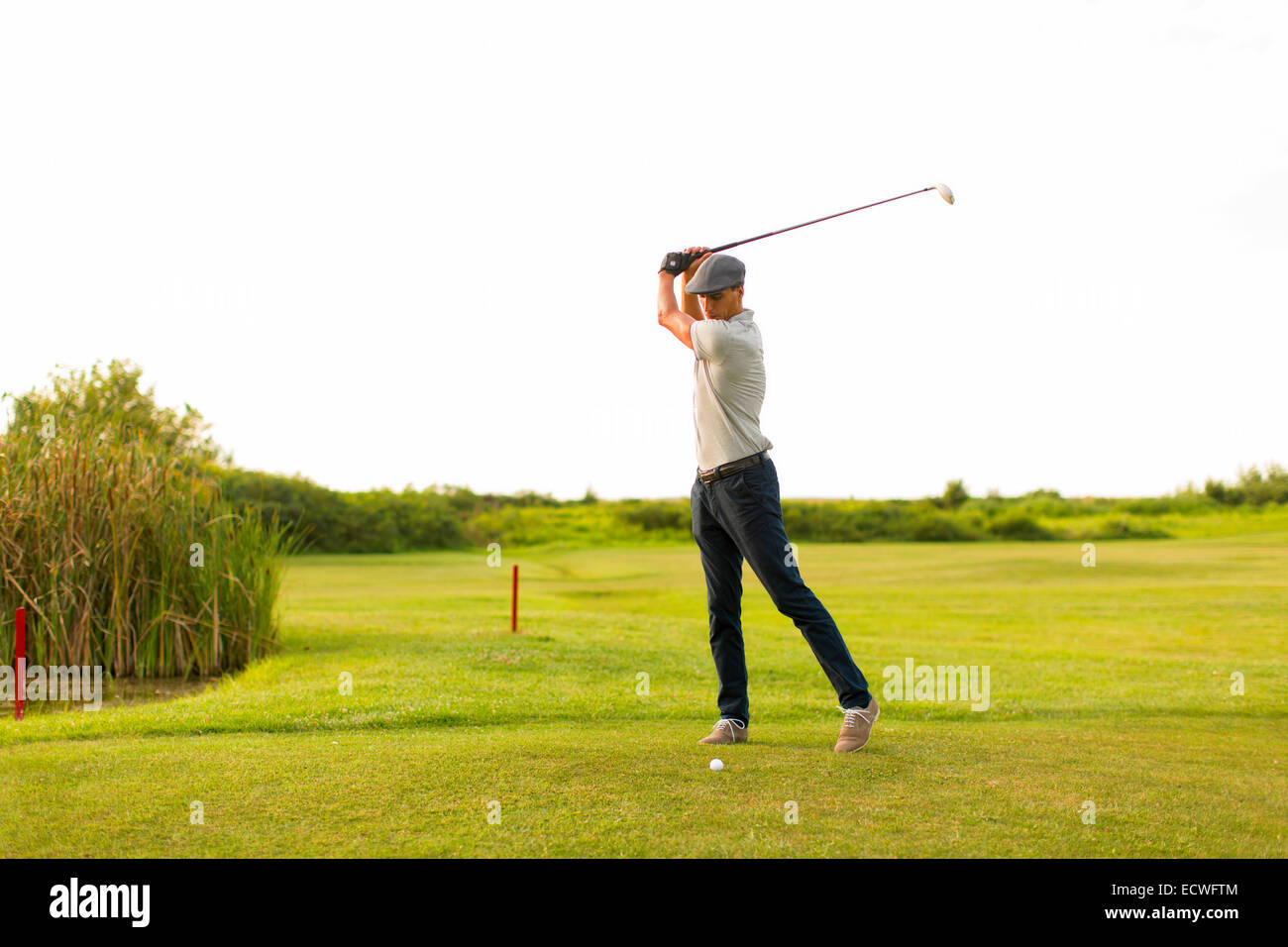 Young man playing golf Stock Photo - Alamy