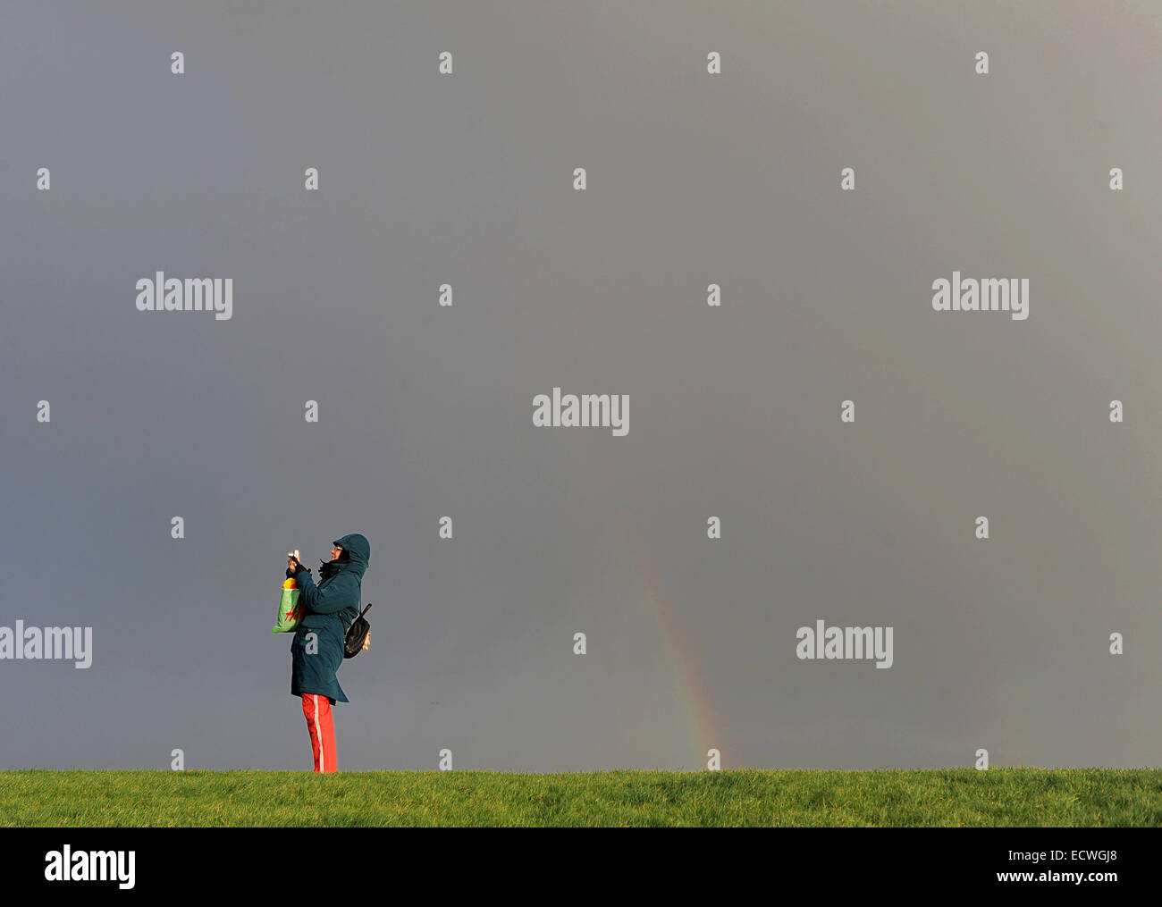 Dorum, Germany. 20th Dec, 2014. A woman takes pictures of the storm in ...