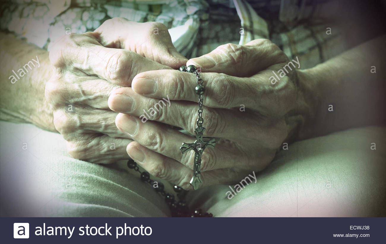 Praying Hands Holding Rosary Beads Stock Photos & Praying Hands Holding ...