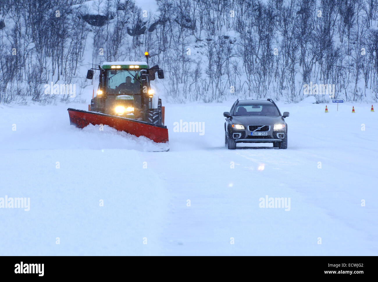 Car driving on snow and ice near the arctic circle in Sweden passing a ...