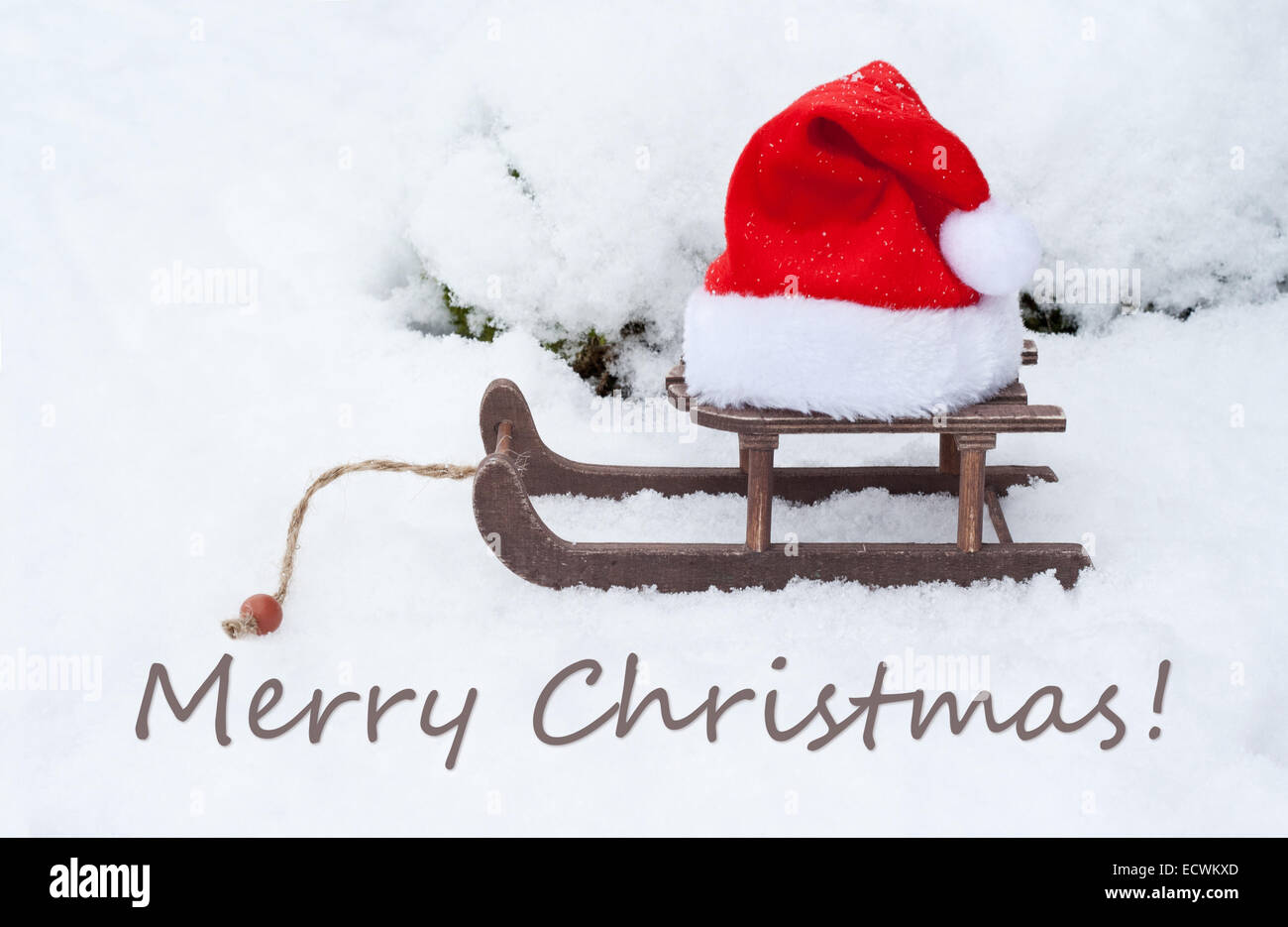 english christmas card with sledge and santa hat Stock Photo - Alamy