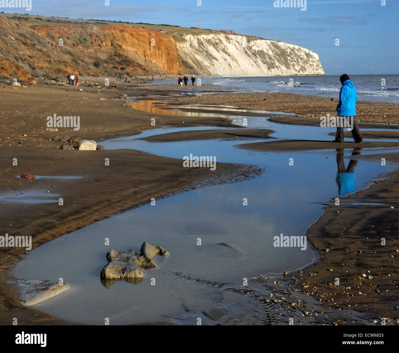 Falling tide exposes sand leaving pools and rivulets on the beach of ...