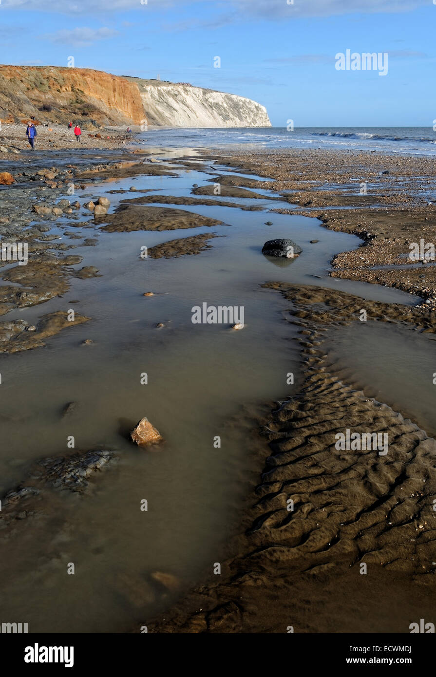 Falling tide exposes sand leaving pools and rivulets on the beach of ...
