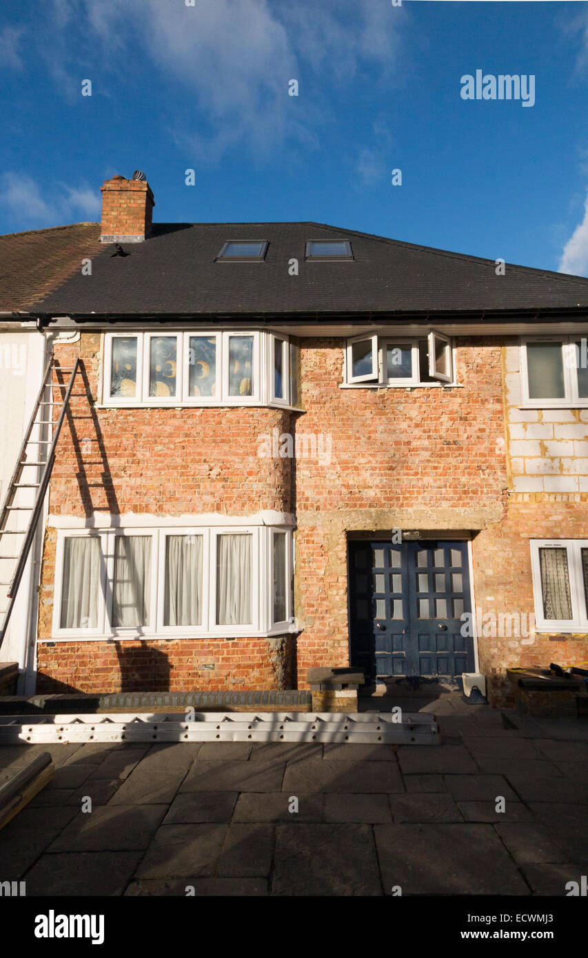 House stripped of render so that its bricks are shown again, ready to ...