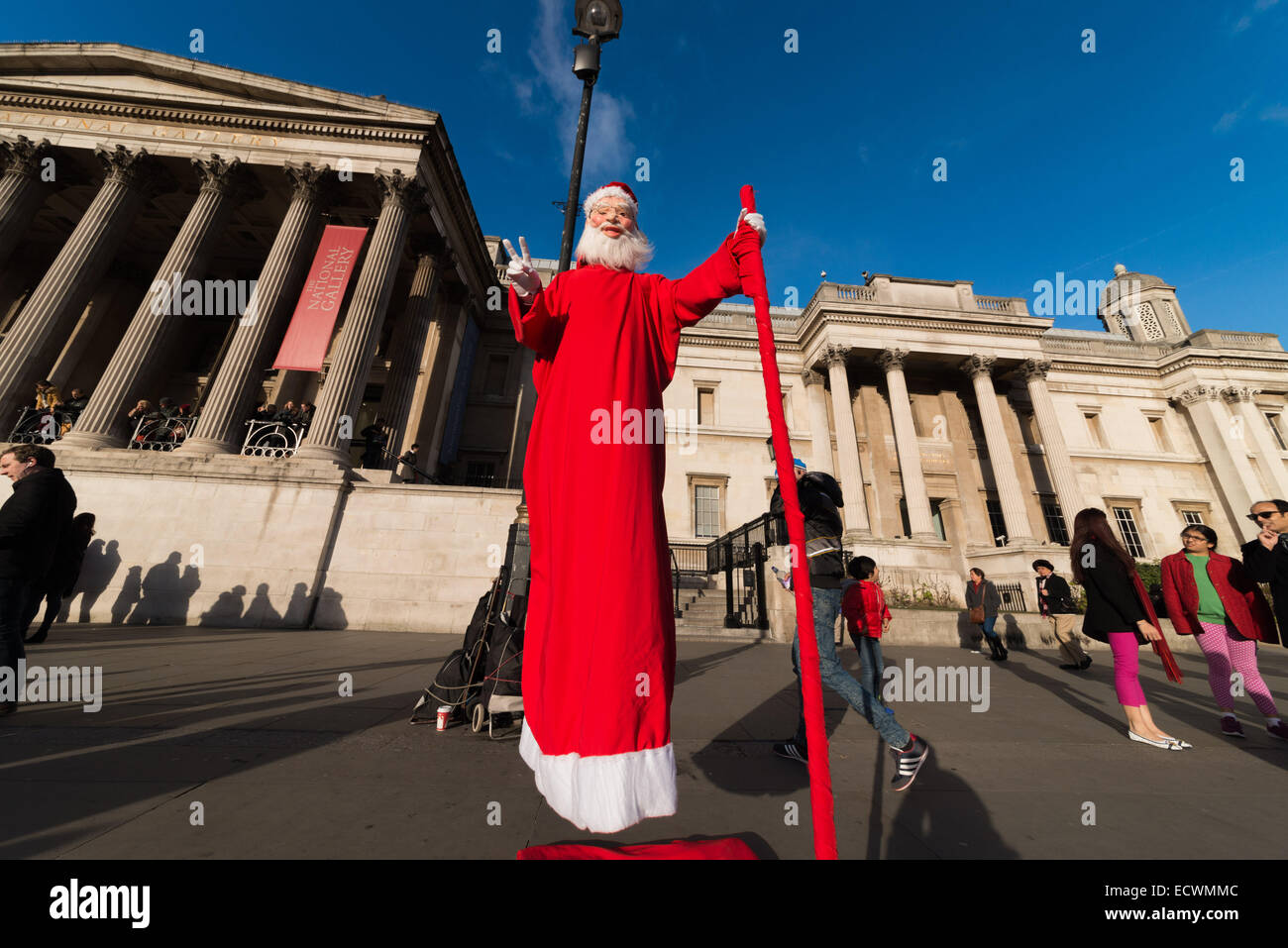 London, UK. 20th Dec, 2014. Santas defying gravity in Trafalgar Square ...