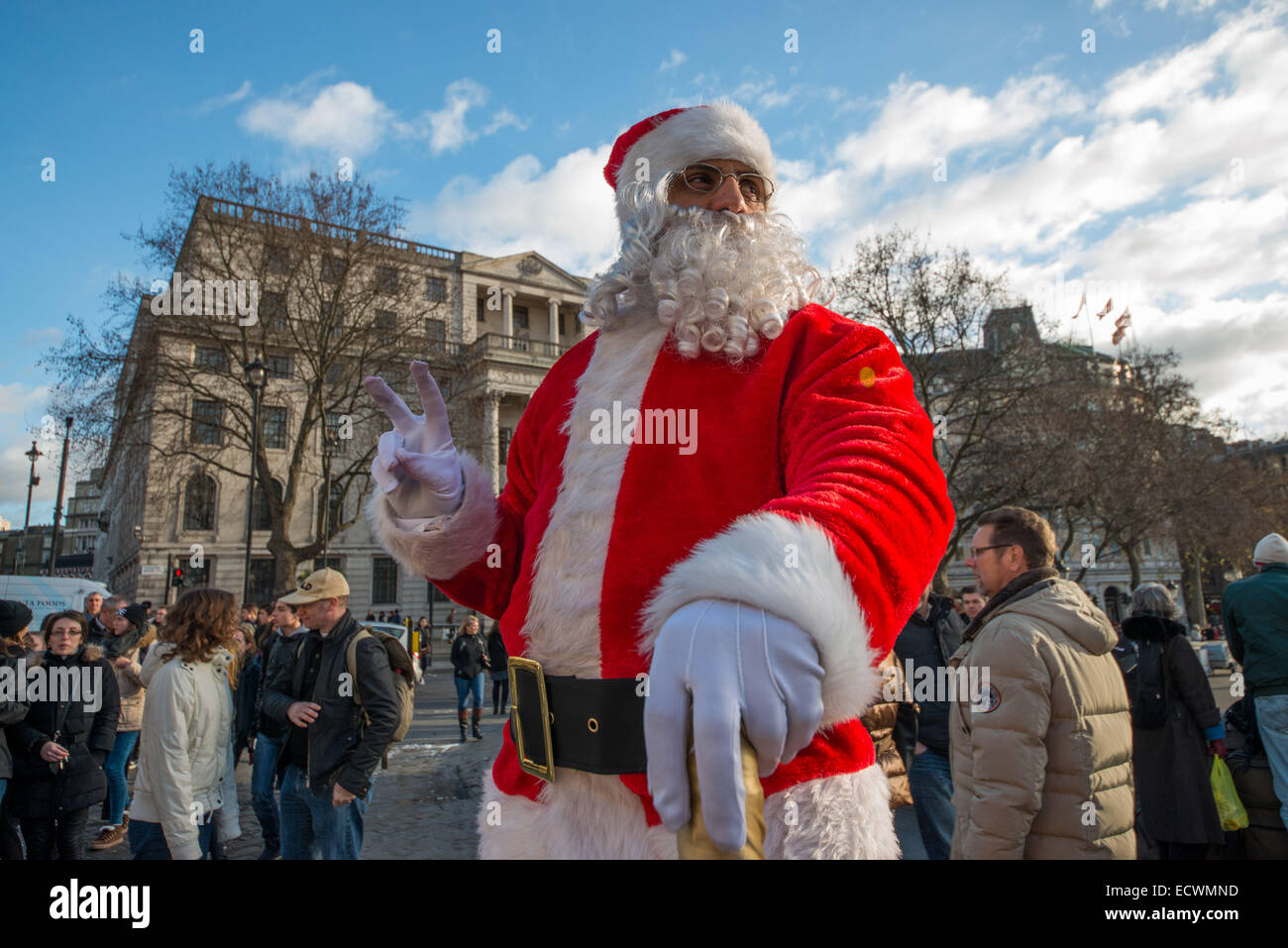 London, UK. 20th Dec, 2014. Santas defying gravity in Trafalgar Square ...