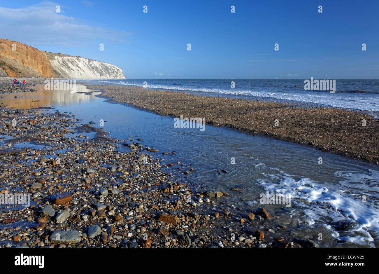 Falling tide exposes sand and pebbles with seawater on the beach of ...