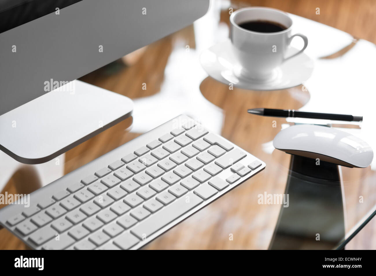Glass desk with modern computer and cup of coffee Stock Photo - Alamy