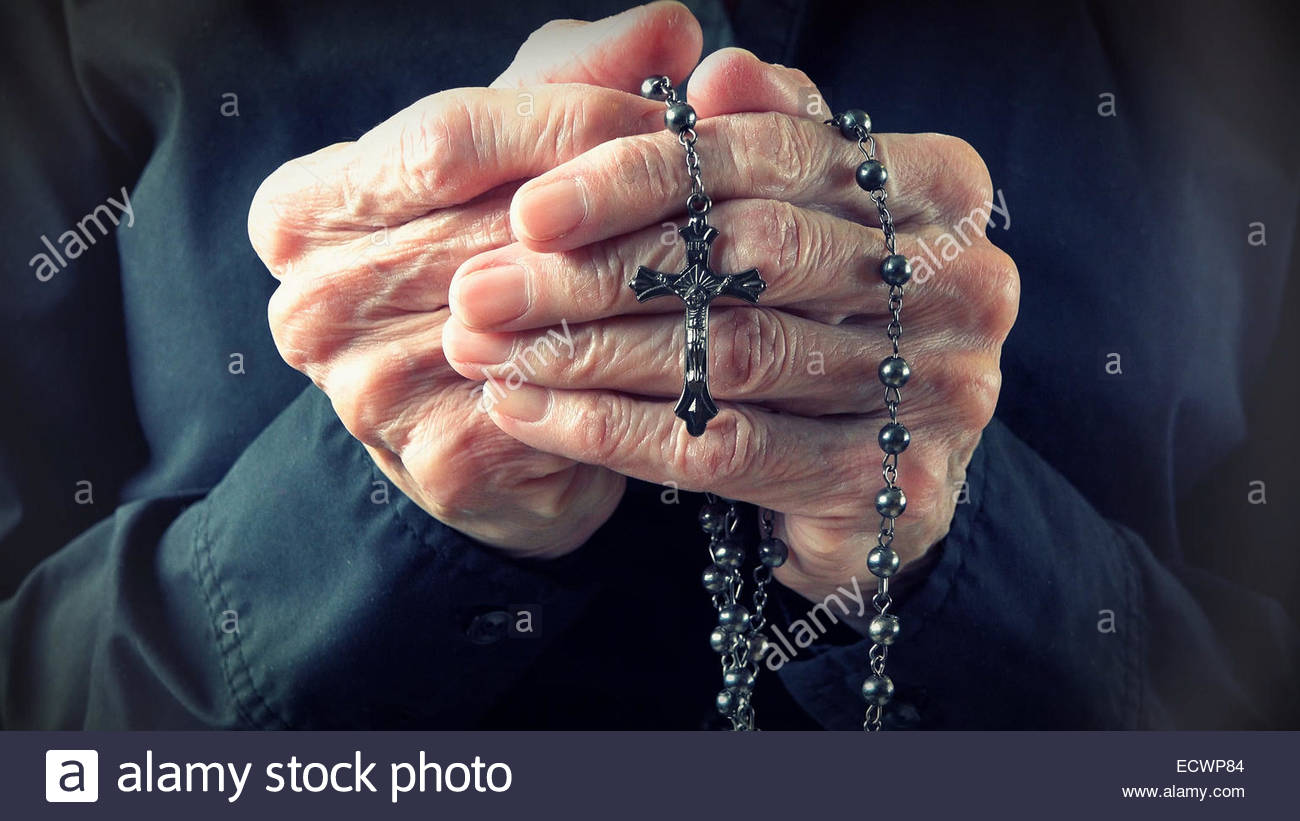 Praying Hands Holding Rosary Beads Stock Photos & Praying Hands Holding ...