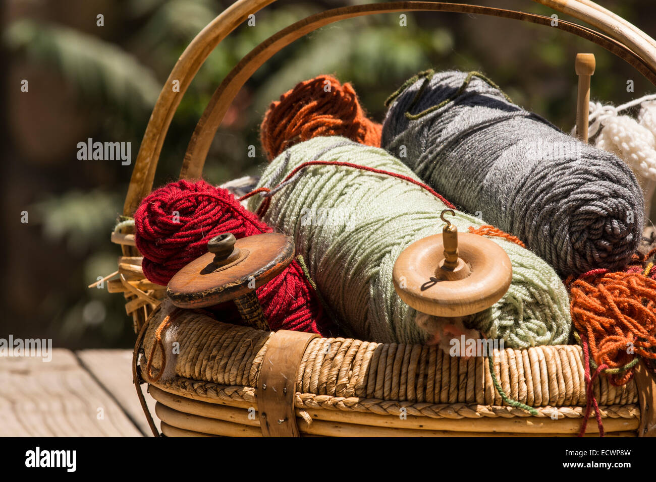 A woven basket full of yarn and a couple of spools Stock Photo - Alamy