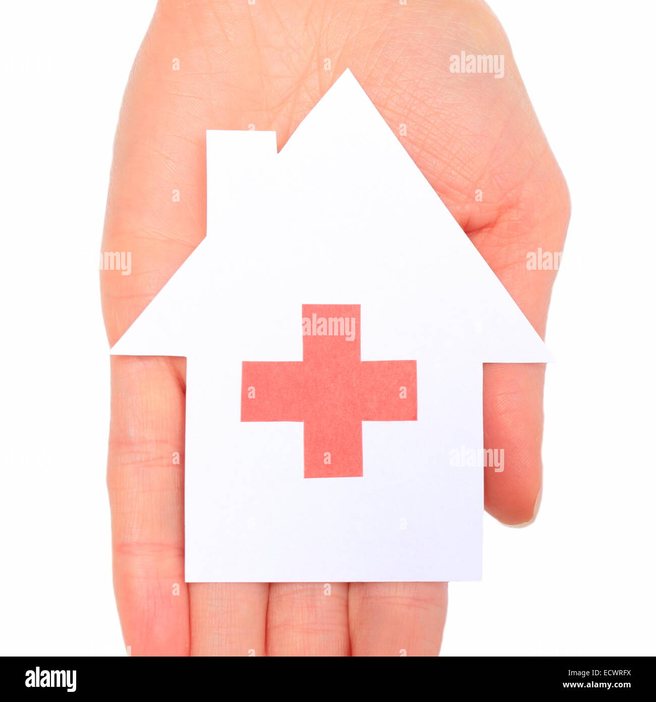 Hand holding paper house with red cross sign, concept for medicine and ...
