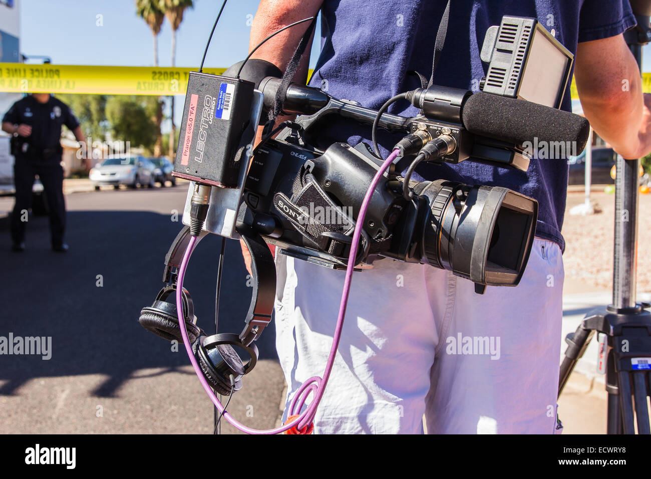 Midsection rear view of male camera operator at crime scene Stock Photo ...
