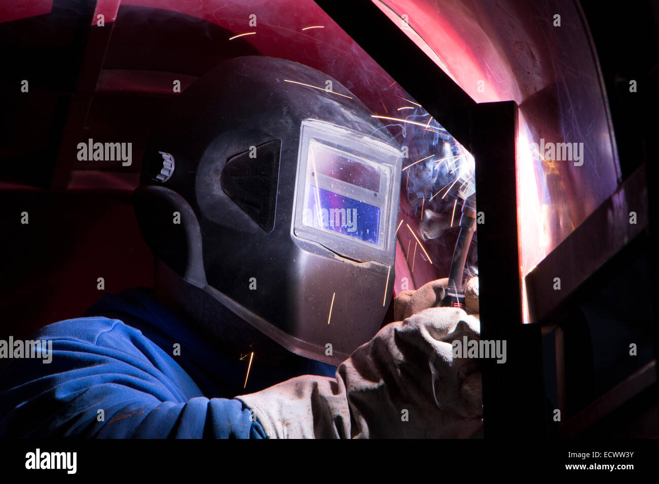 Man welding in horse trailer Stock Photo - Alamy