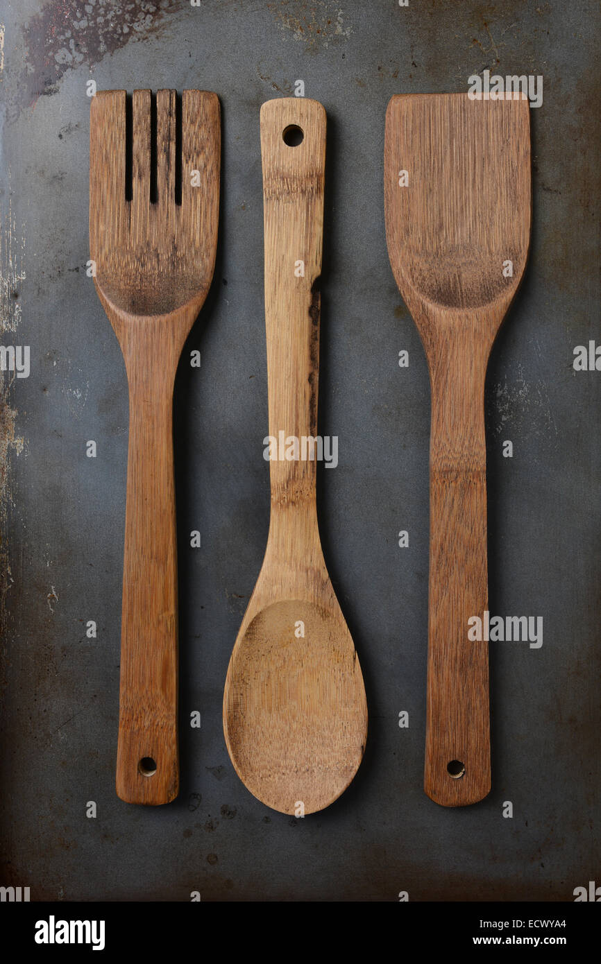 High angle shot of three wood kitchen utensils on an old and well used ...