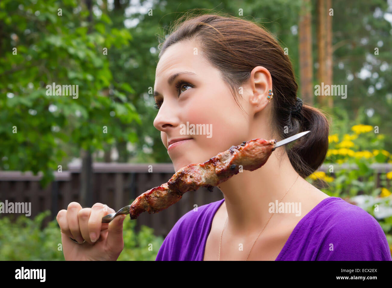 woman enjoying barbecue outdoors Stock Photo - Alamy