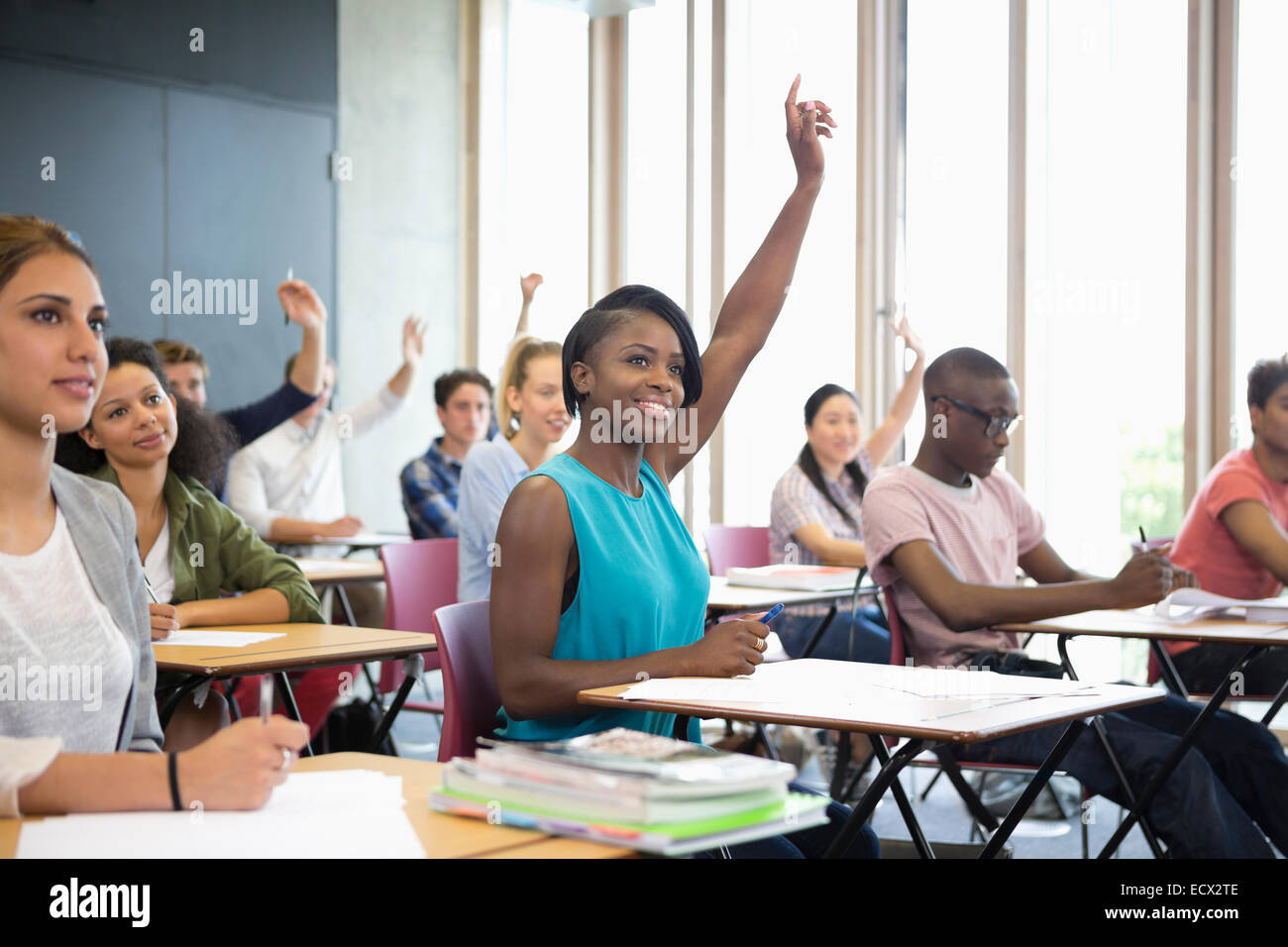 Motivated university students raising their hands at seminar Stock ...