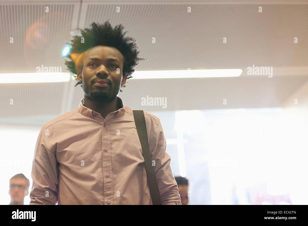 Low-angle view of university student standing in classroom Stock Photo ...
