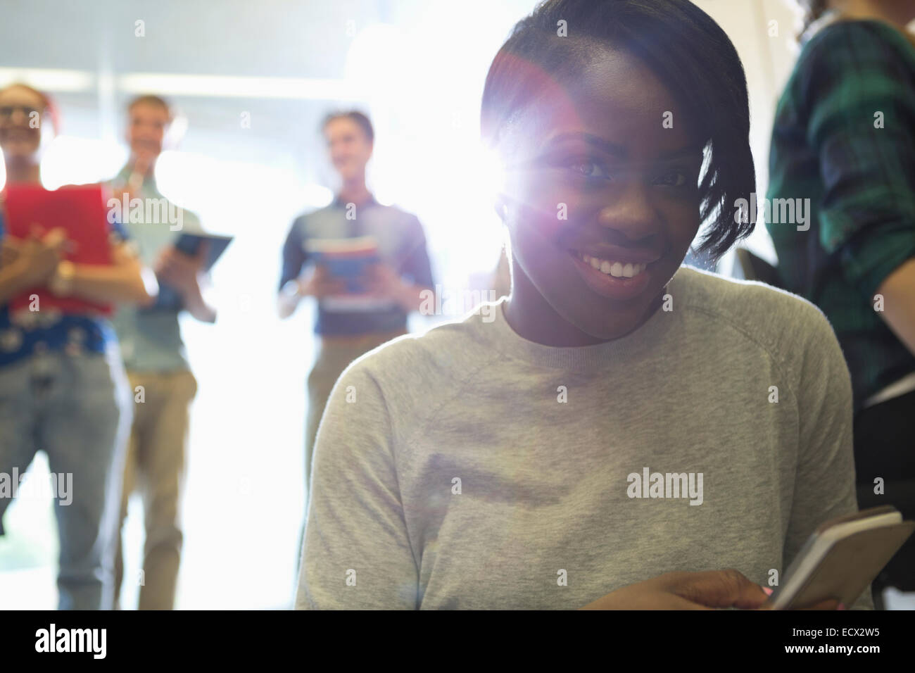 Portrait of university student texting in corridor Stock Photo - Alamy