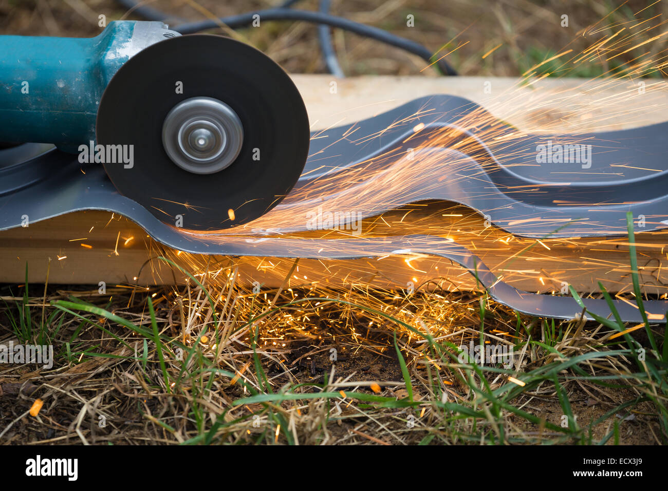sharpening and cutting of iron by abrasive disk machine Stock Photo - Alamy