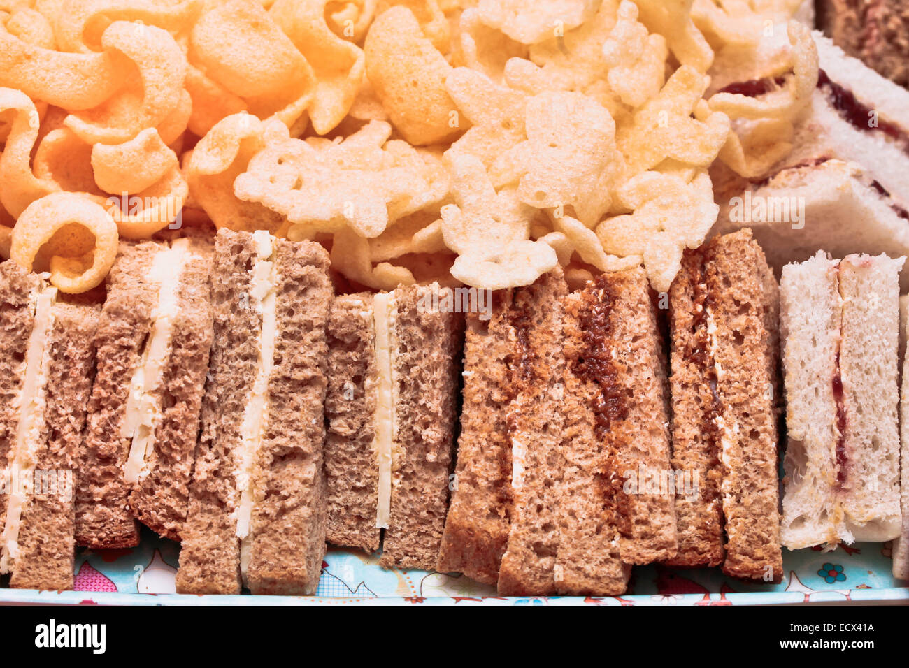 Cheese sand wiches and crisps on a plate Stock Photo - Alamy