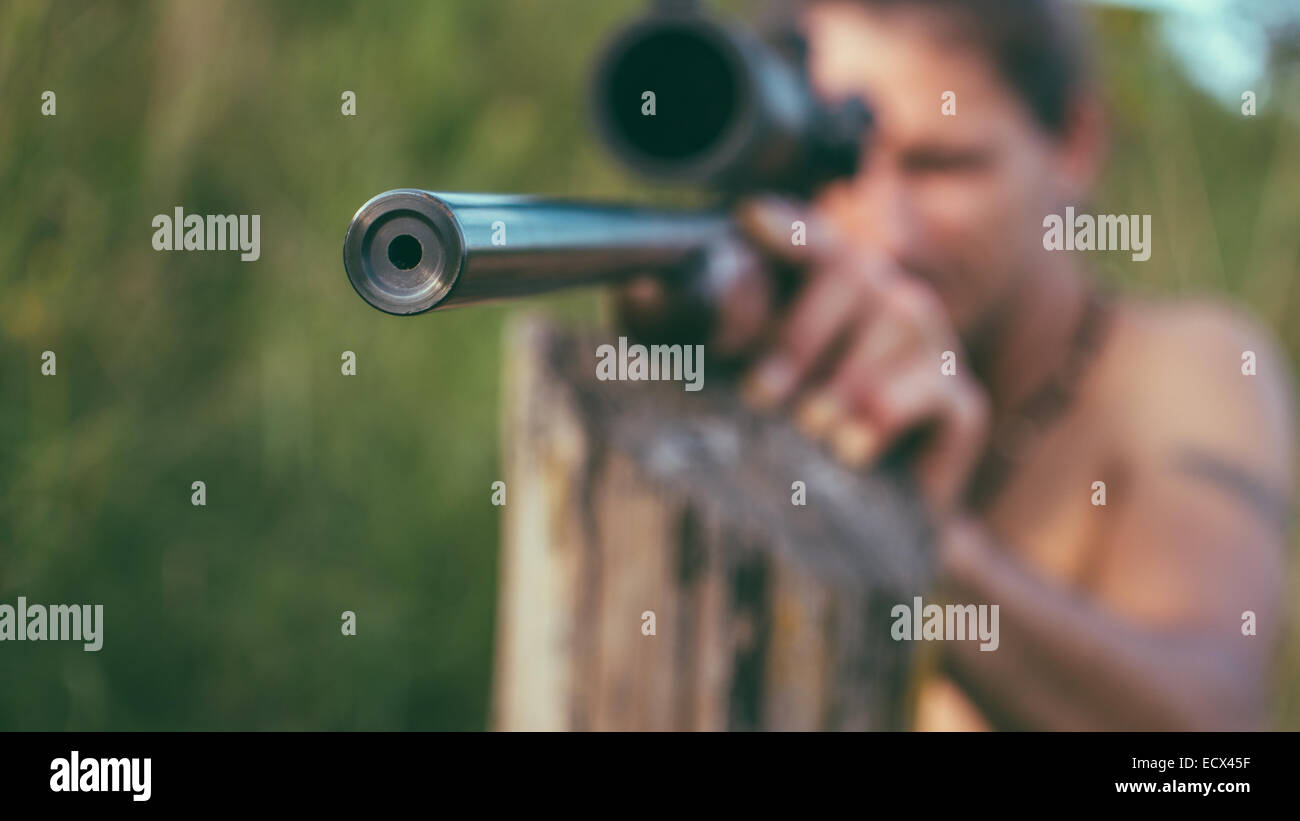 Man with rifle aiming at target Stock Photo - Alamy
