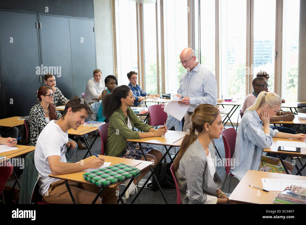 University students receiving test results from professor Stock Photo ...