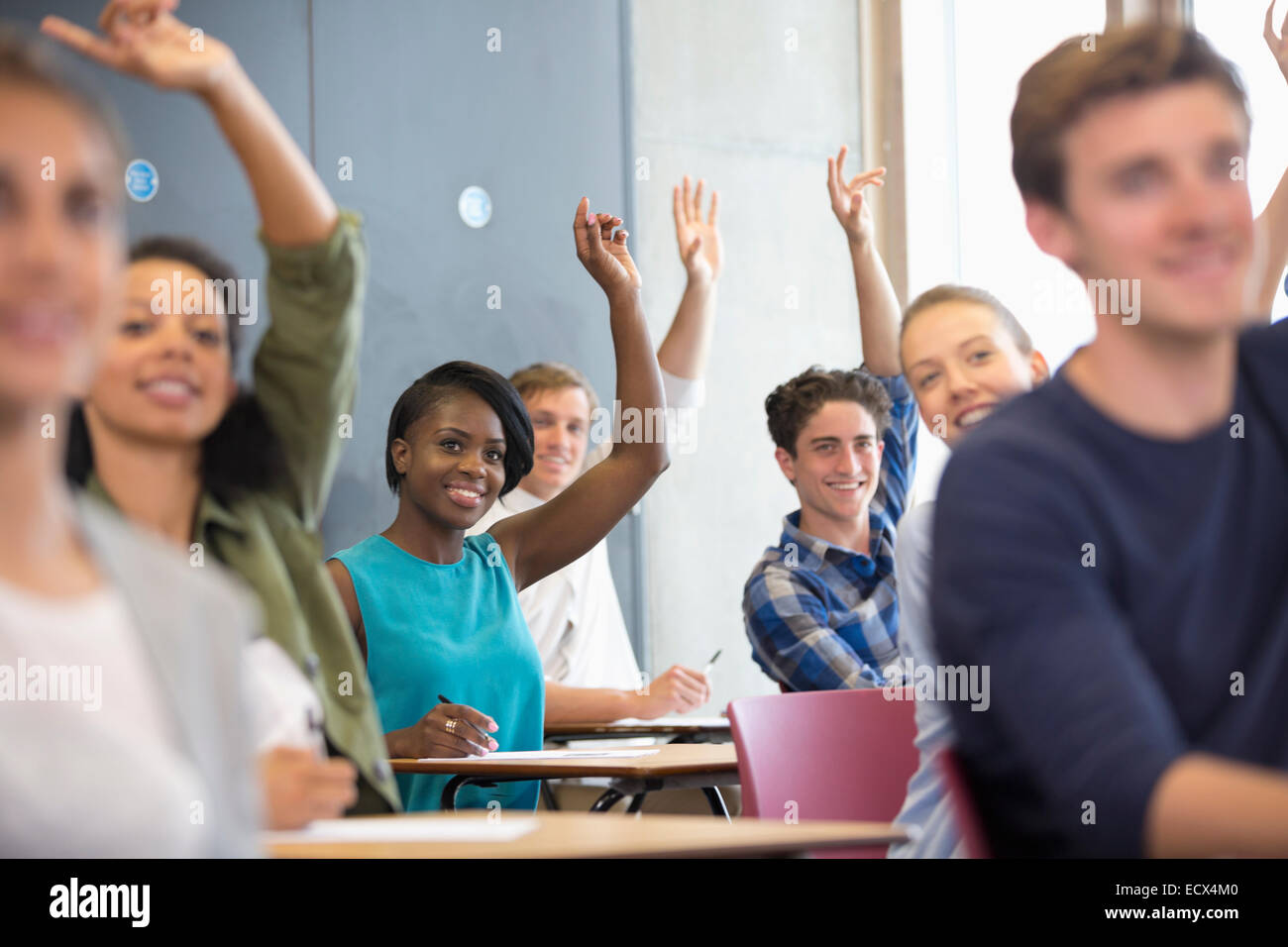 University students raising hands at seminar Stock Photo - Alamy