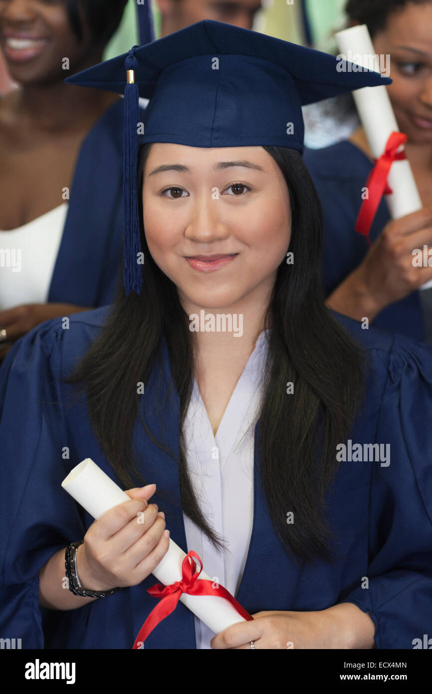 Female student smiling at camera and holding diploma Stock Photo - Alamy