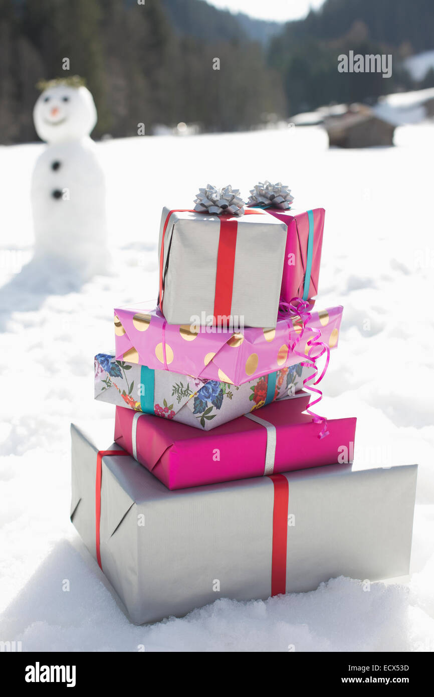 Stack of Christmas gifts in snow Stock Photo - Alamy