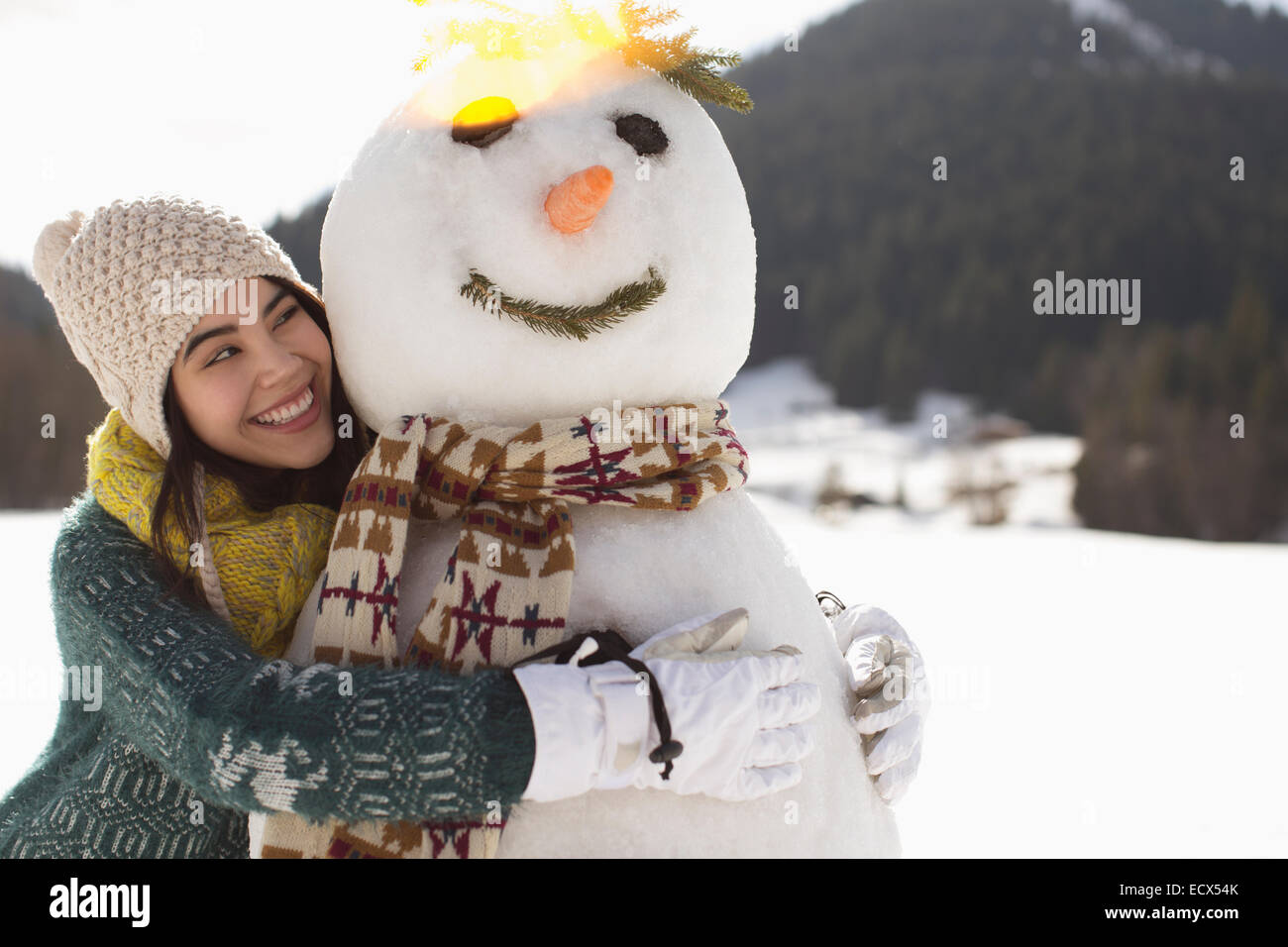 Woman hugging snowman Stock Photo - Alamy