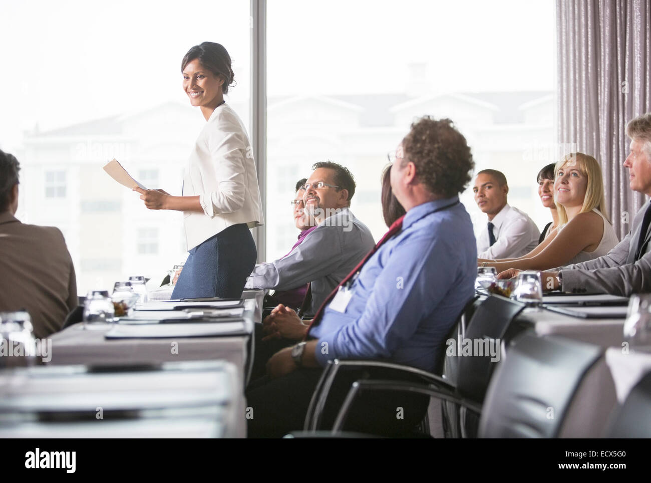 Portrait of businesswoman giving presentation in office Stock Photo - Alamy