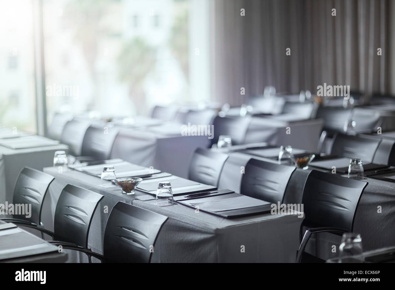 View of empty conference room with tables Stock Photo - Alamy