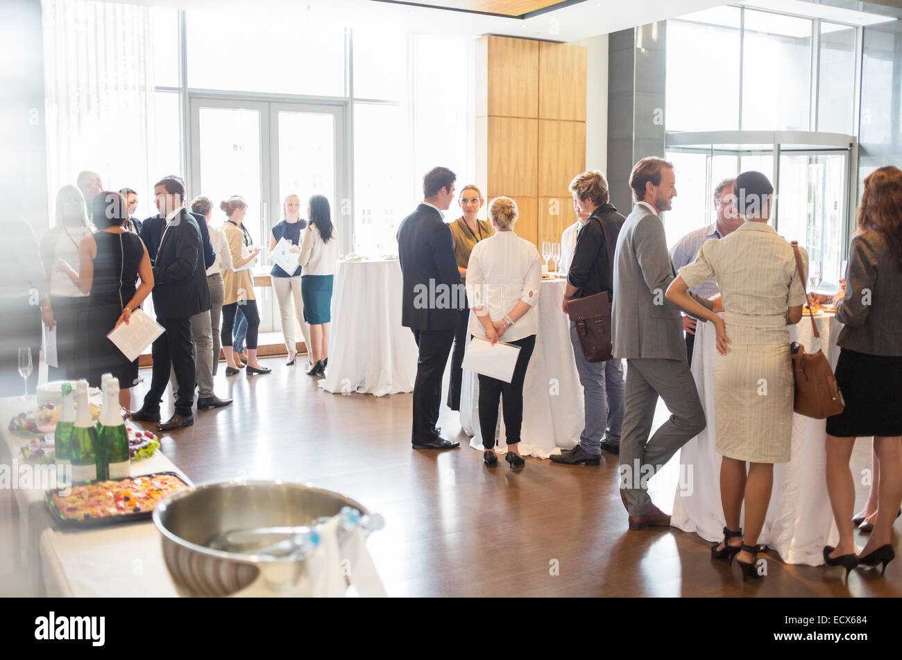 Group of conference participants standing in lobby of conference center ...