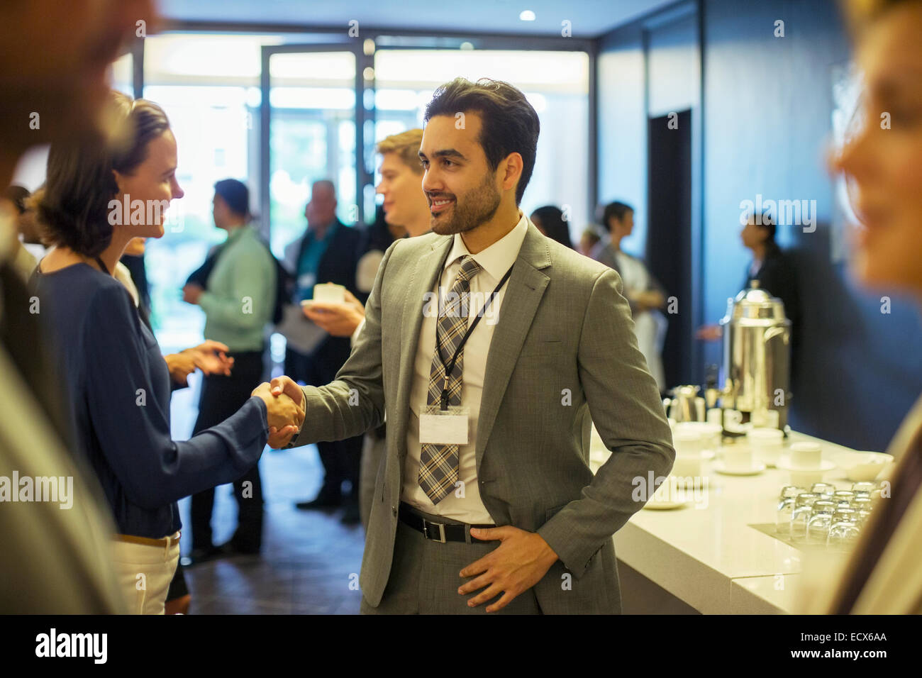 Business people shaking hands during reception in office Stock Photo ...
