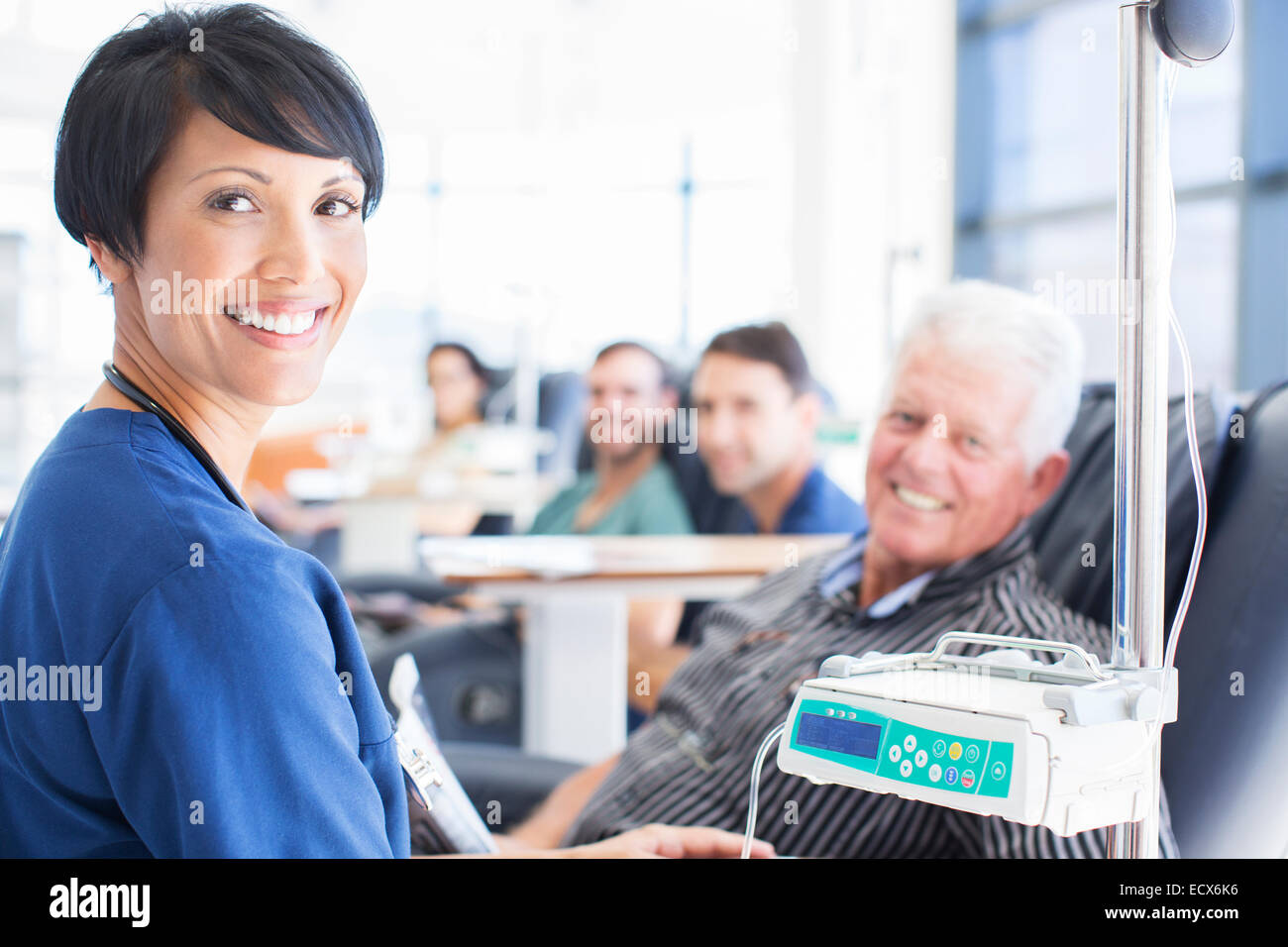 Portrait of smiling doctor assisting patient undergoing medical ...