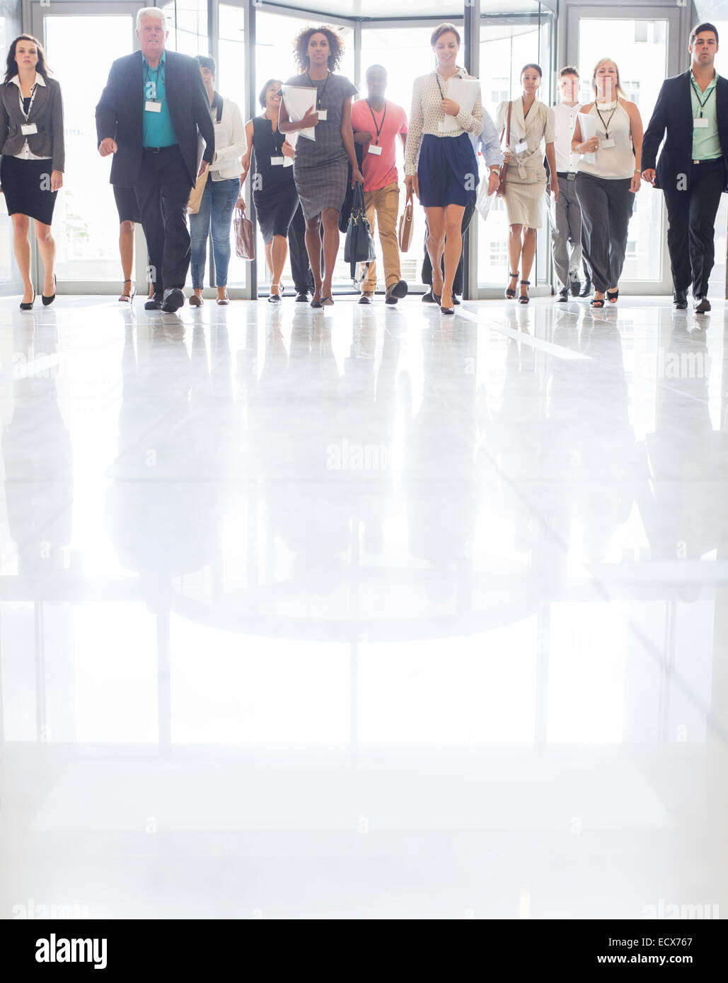 Large group of business people walking in office Stock Photo - Alamy
